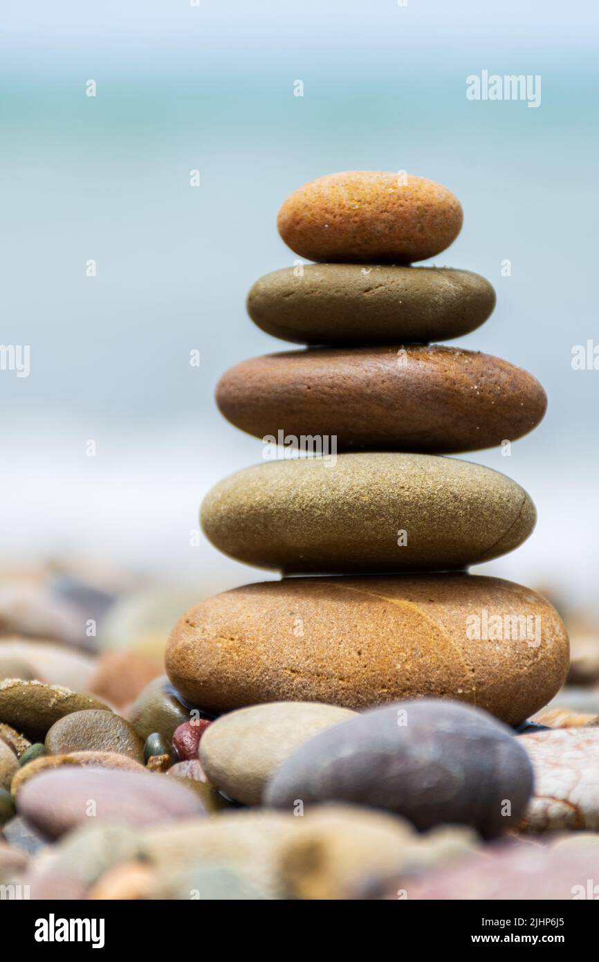 Close-up pyramid stones balance on the beach. Calm. Zen-like concept ...