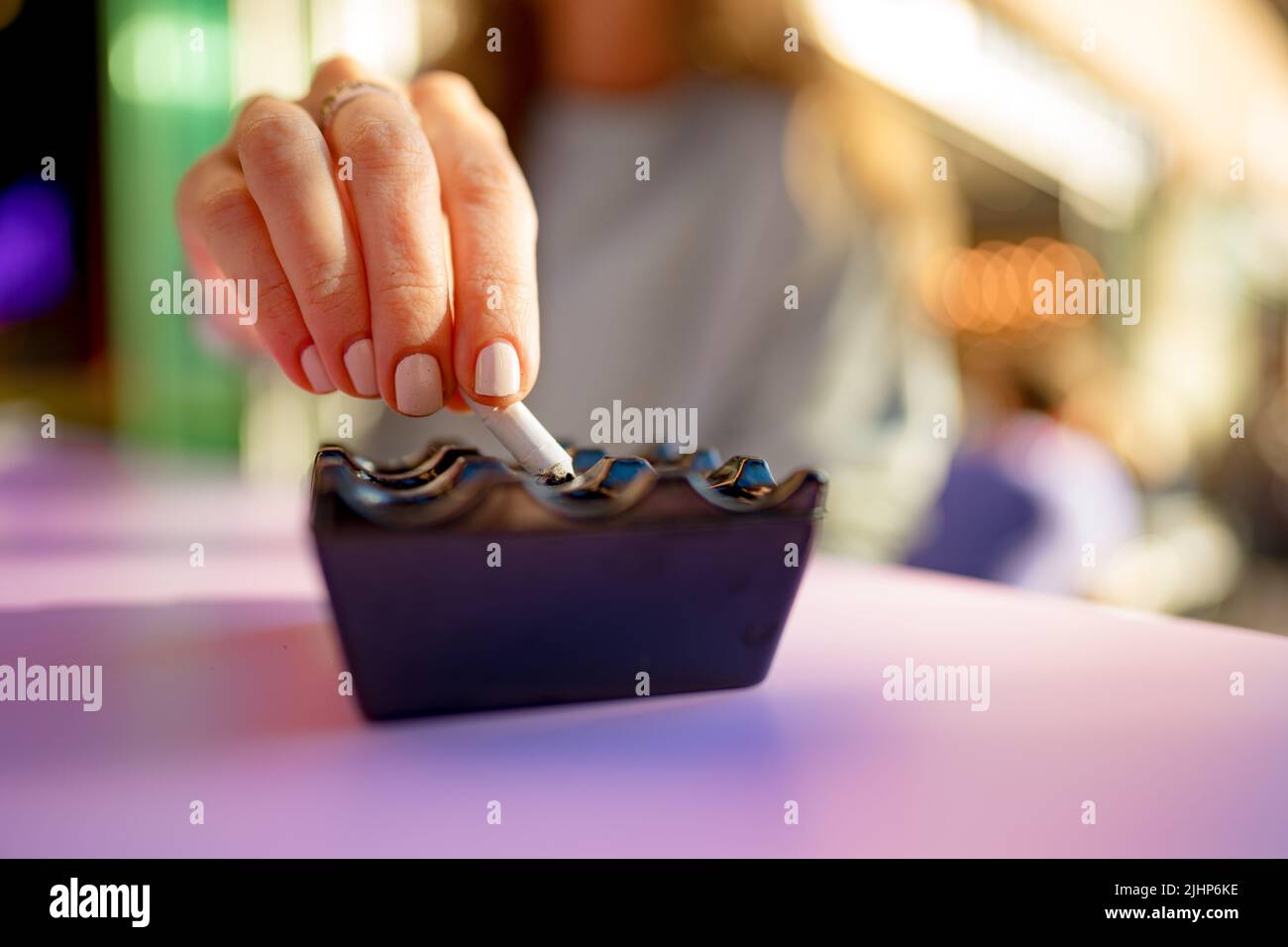 Close up of a woman putting finished cigarette in an ashtray Stock ...