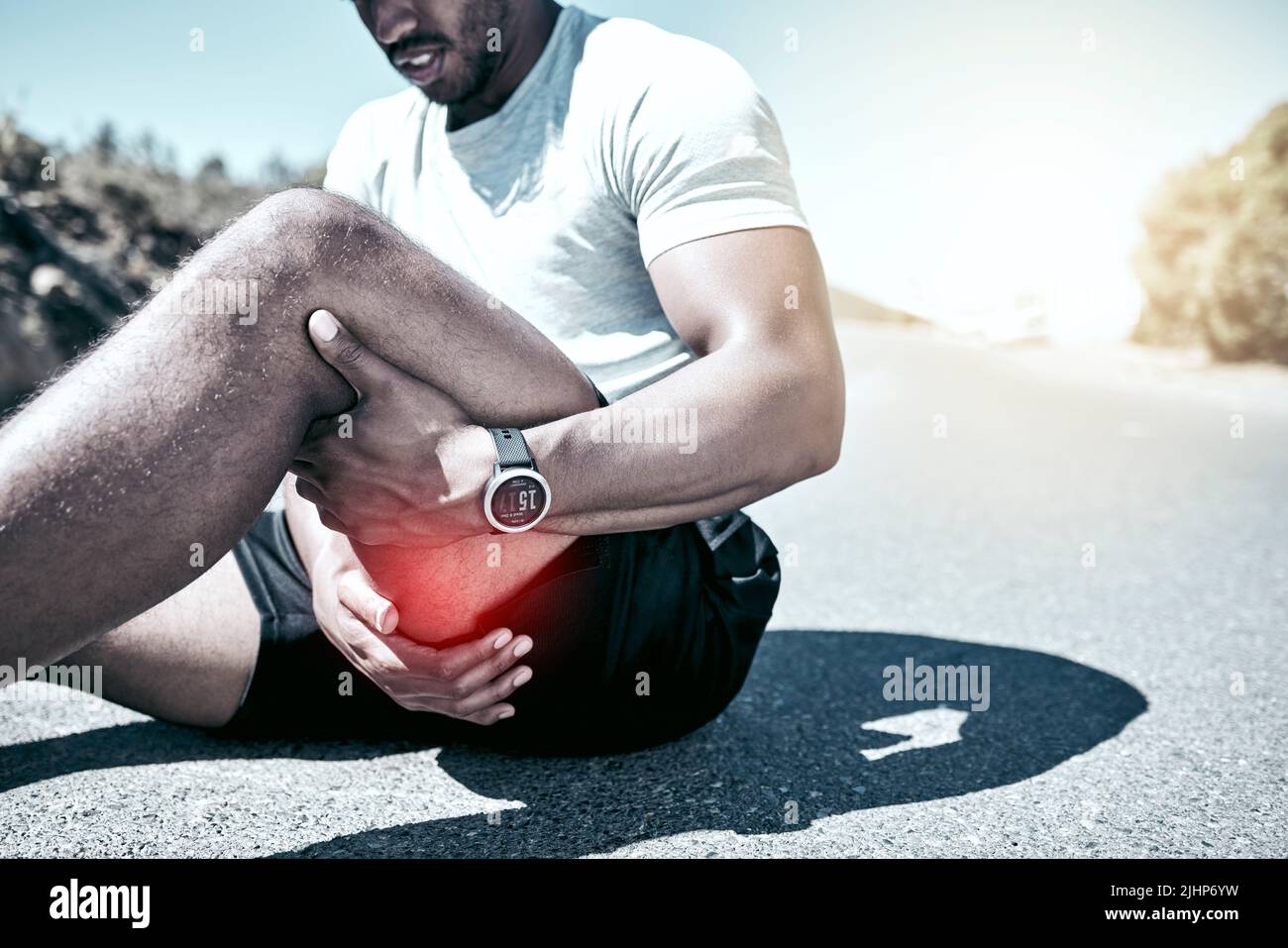 Closeup fit mixed race man holding his leg in pain while exercising ...