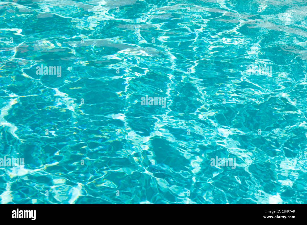 turquoise color background of swimming pool water with ripples in ...