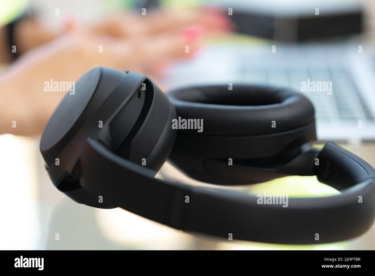 Black wireless headphones lying on a glass table Stock Photo - Alamy