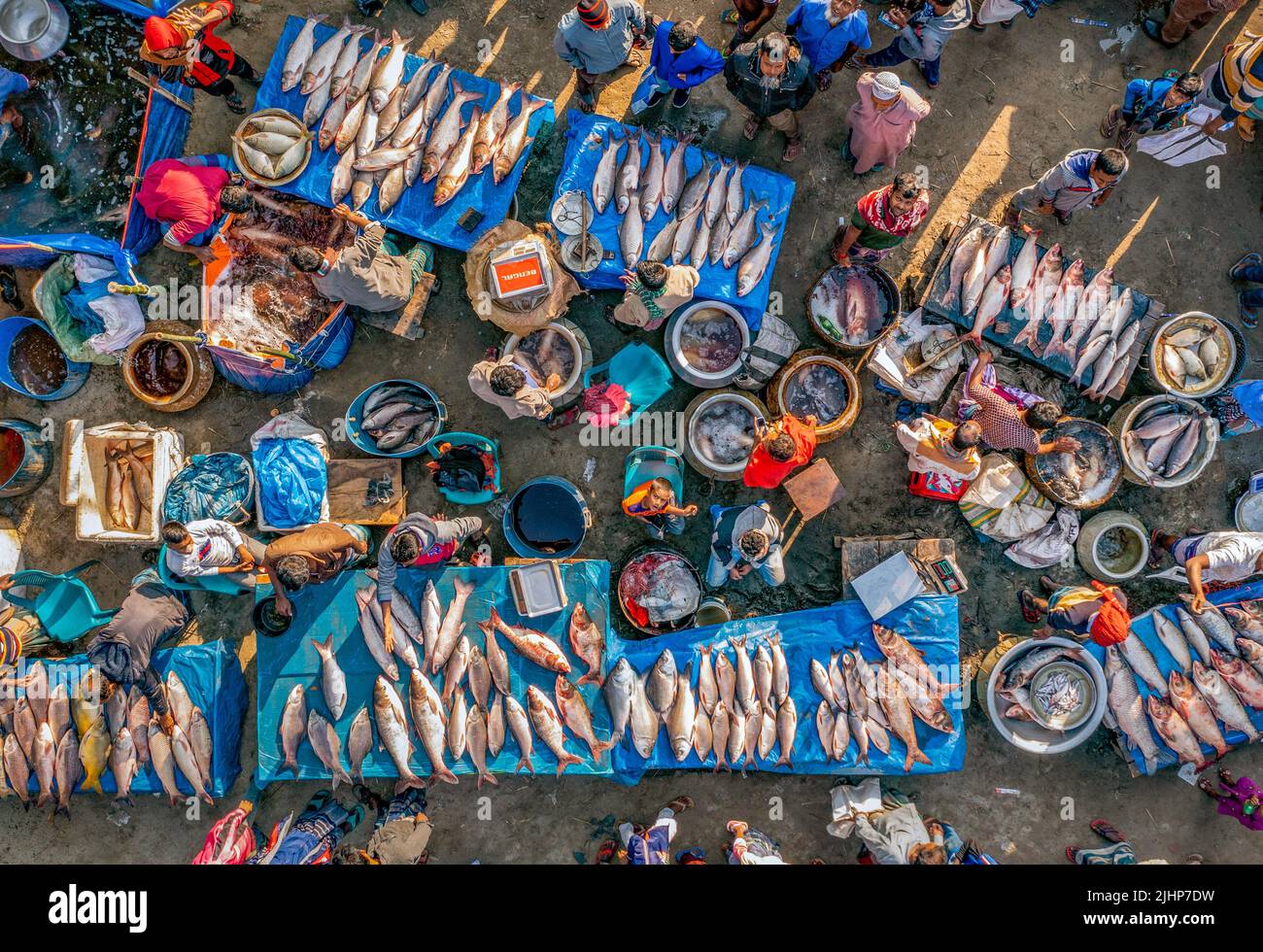 Aerial view of fish being sold at a bustling village fair in rural ...