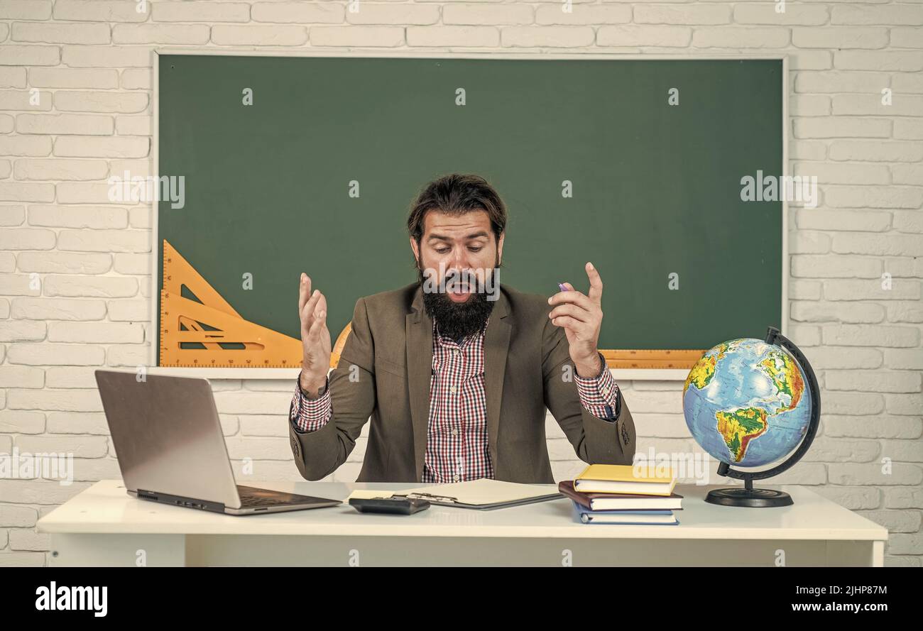mature bearded man teacher in costume sit in school classroom with ...