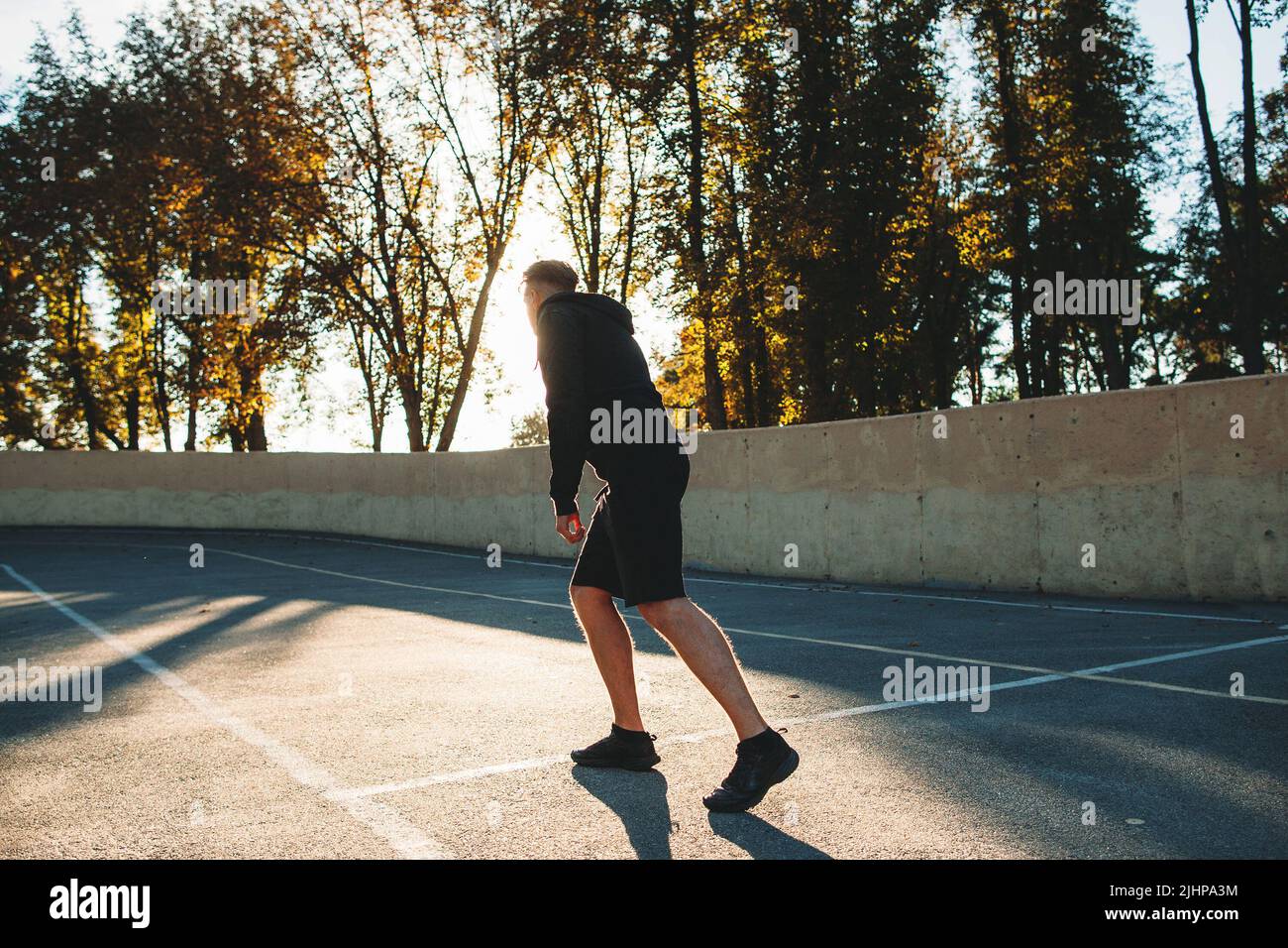 Tired man going on stadium race after training Stock Photo - Alamy