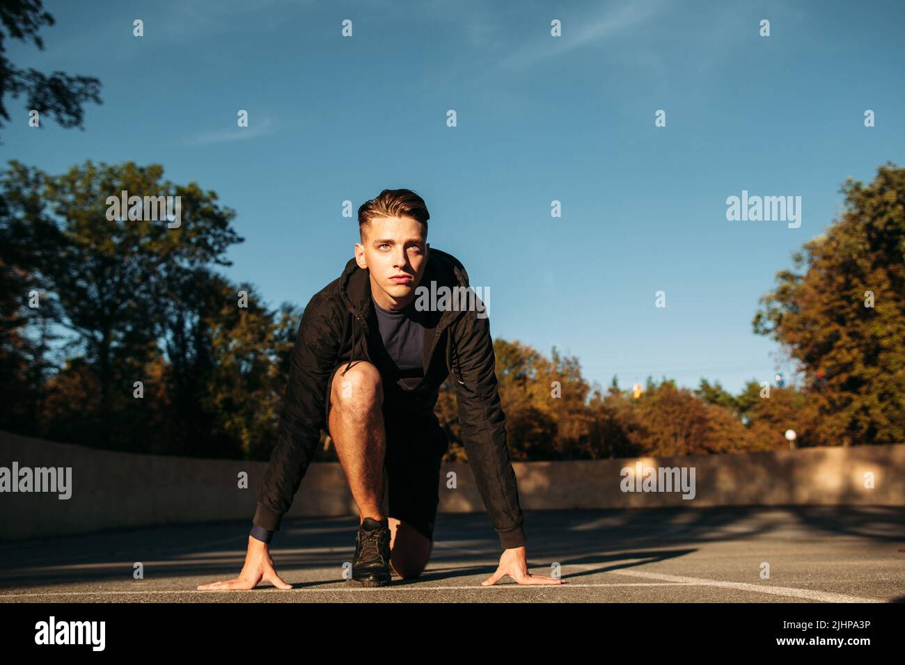 Sprinter standing at the start before race Stock Photo - Alamy