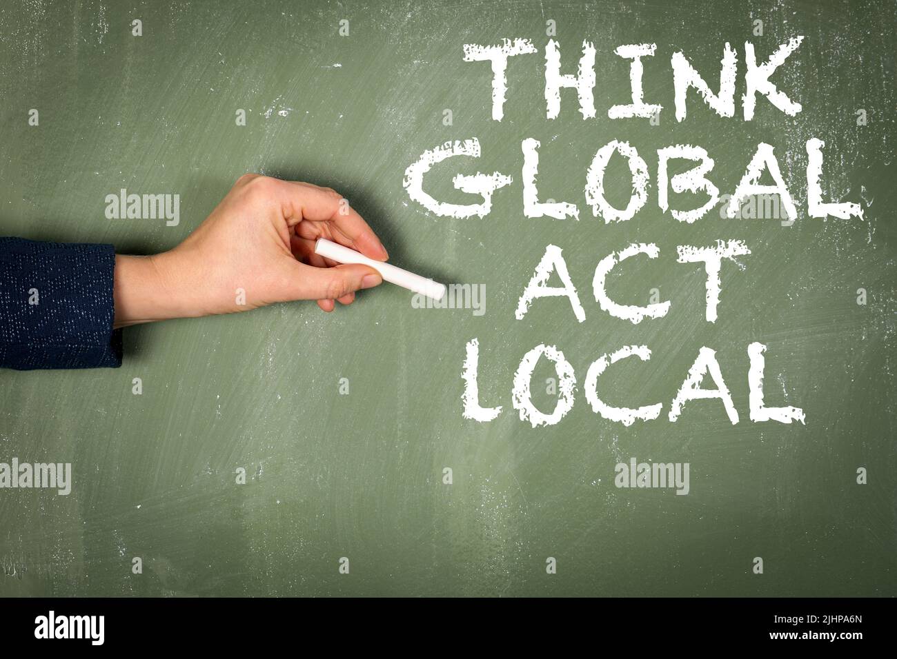 Think global act local. Text on a green chalkboard background Stock ...