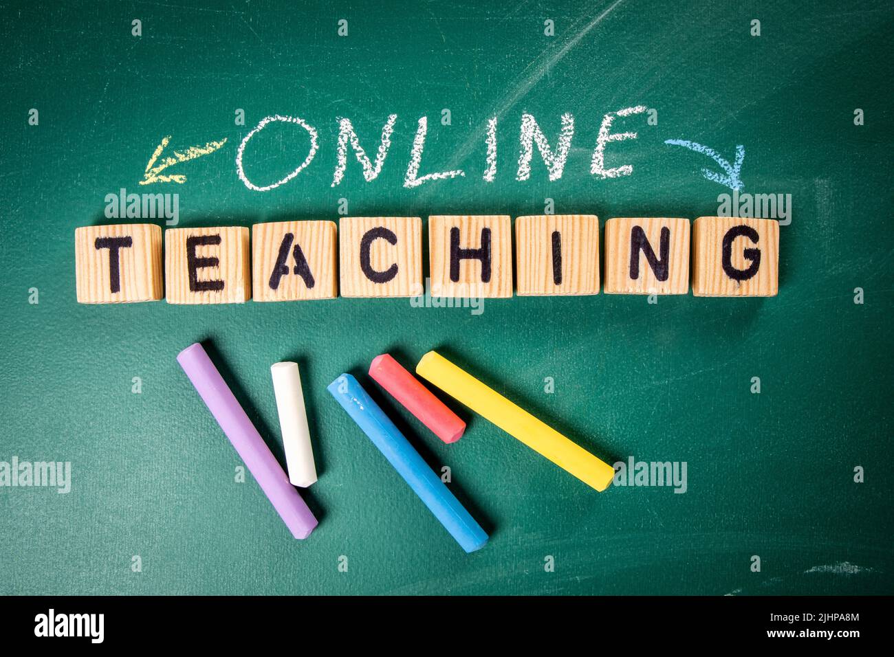 Teaching concept. Wooden alphabet letters and pieces of chalk on a ...