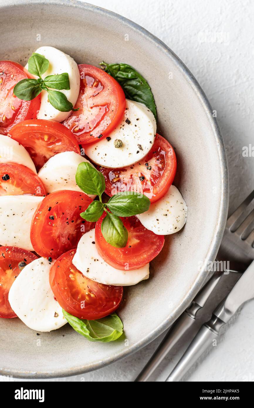Traditional Caprese salad with tomatoes mozzarella basil and olive oil ...