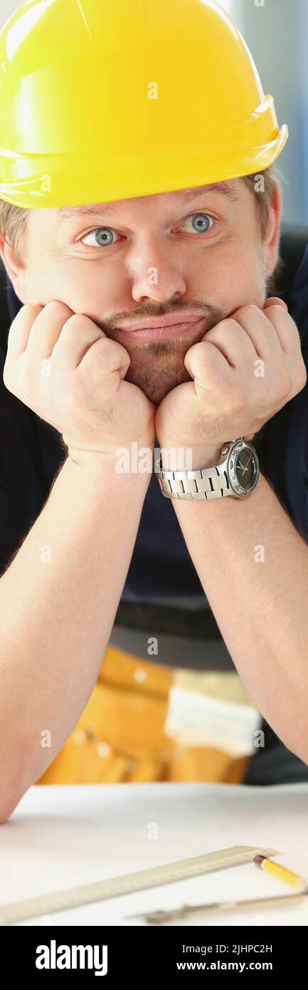 Worker man wearing architect hardhat thinking, looking bored and tired ...