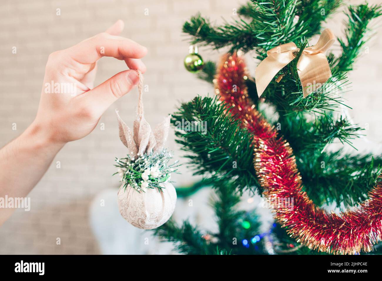 Christmas tree decorating with sparkling toy Stock Photo - Alamy
