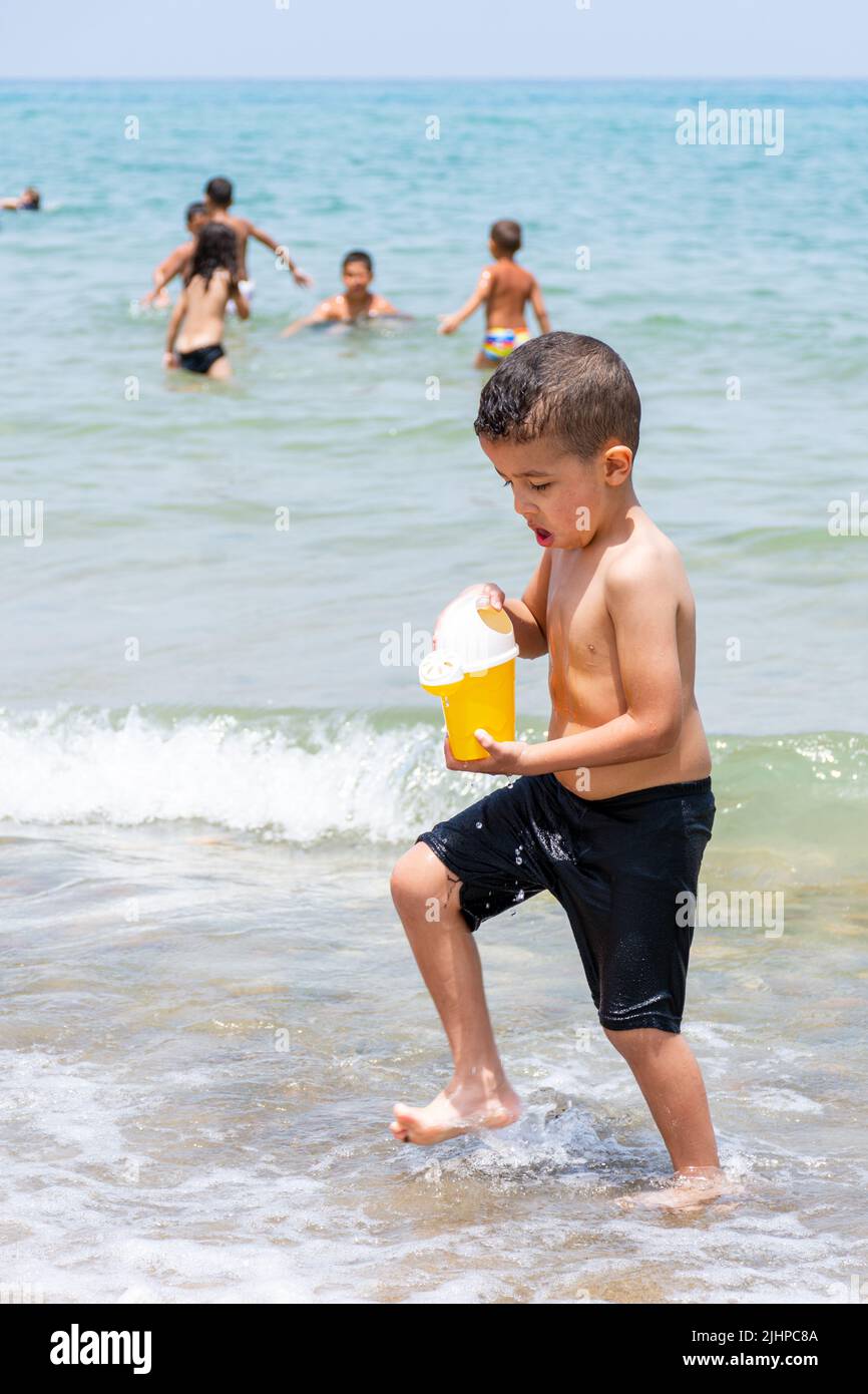 Young boy playing on the beach. Summer vacation concept Stock Photo - Alamy