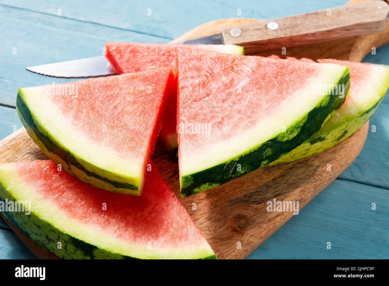 Fresh watermelon slices on blue wooden table Stock Photo - Alamy