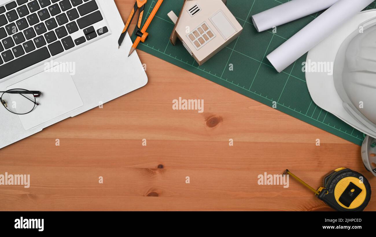Engineer, Architect office desk with laptop, blueprints, hard hat and ...