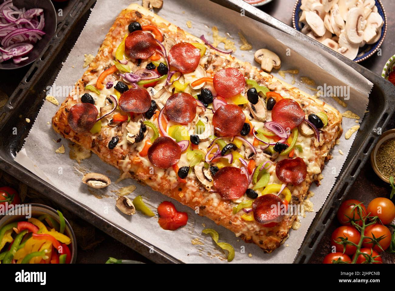 Delicious Homemade rectangular pepperoni pizza on a rustic table with ...