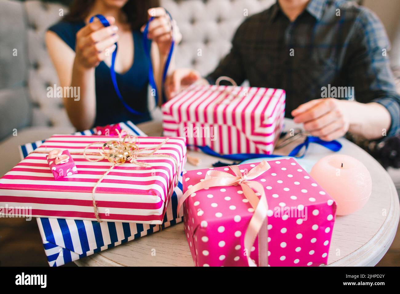 Couple wrapping gifts for family and friends Stock Photo - Alamy