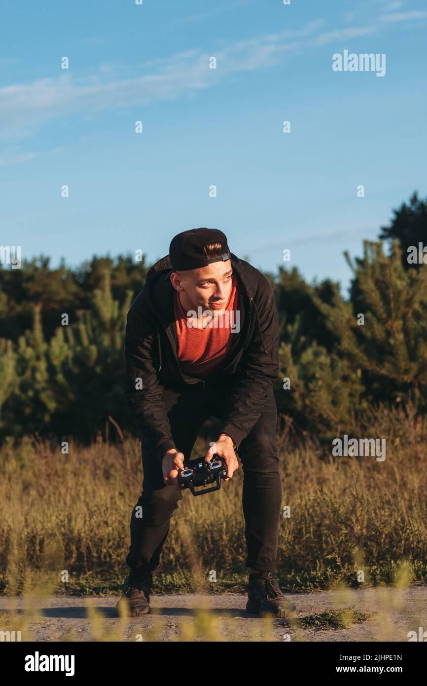 Excited man running drone outdoor, free space Stock Photo - Alamy