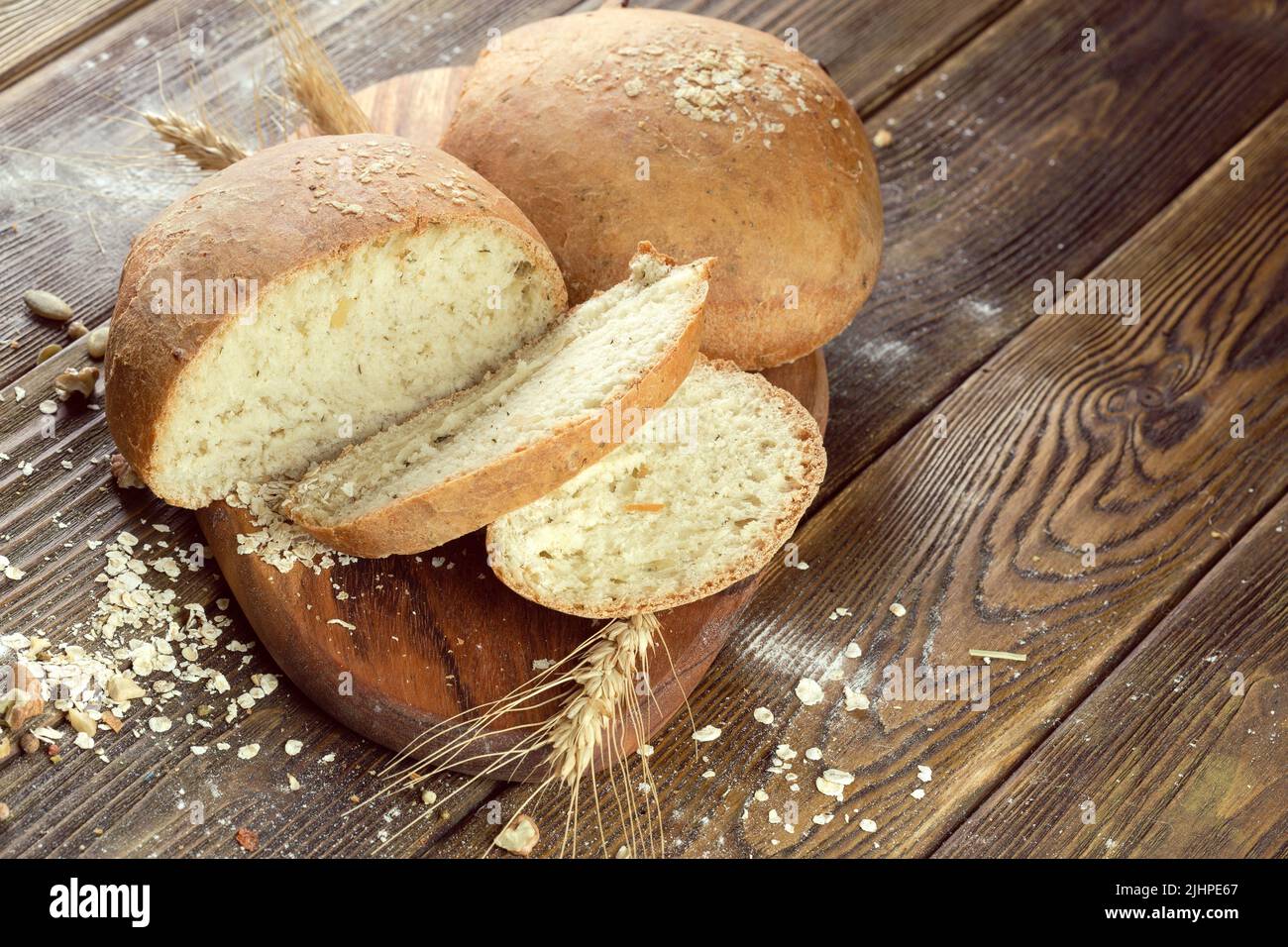 baked bread on wooden table background Stock Photo - Alamy