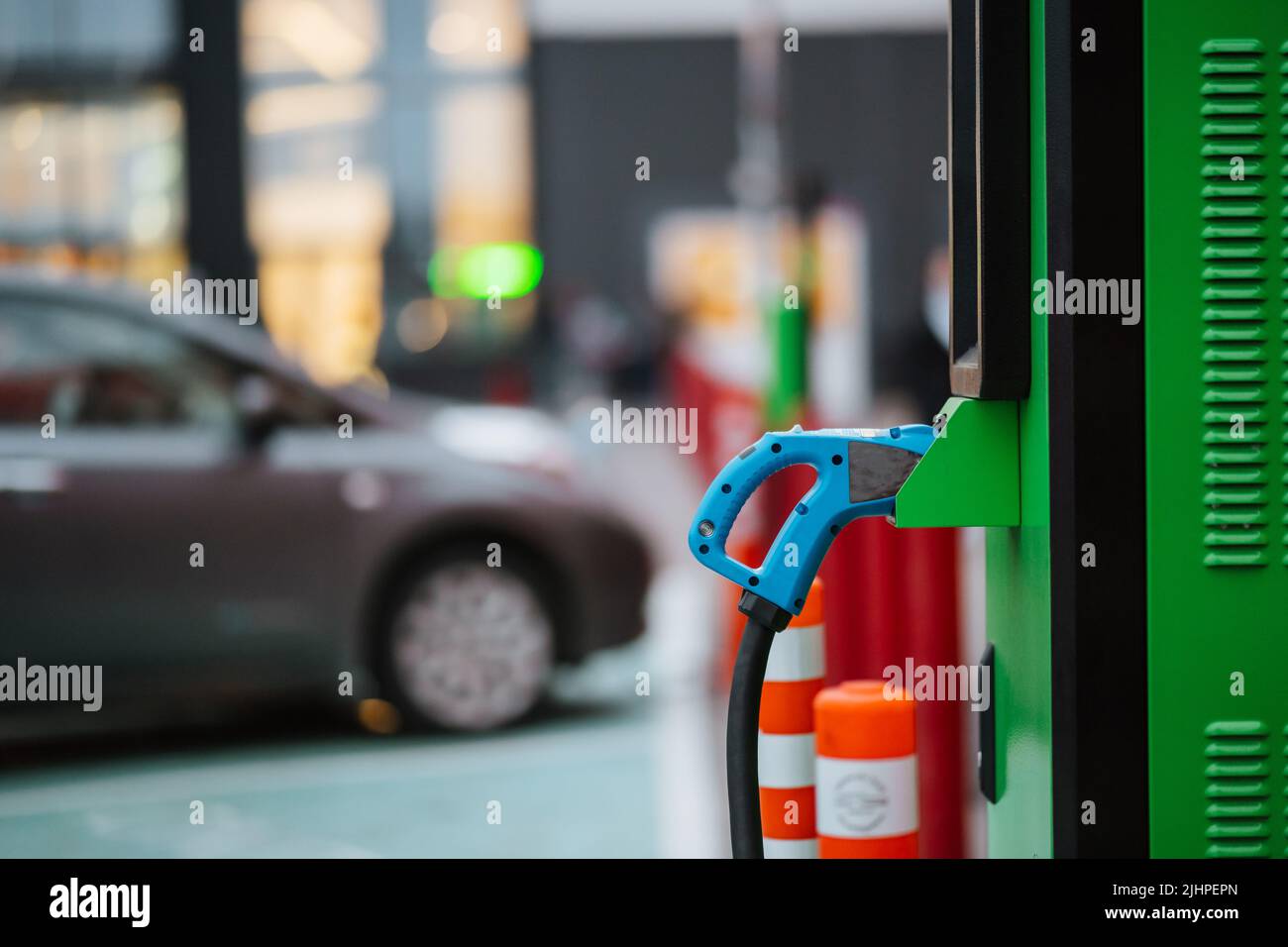 Close up power cord for electric car. Green station Stock Photo - Alamy