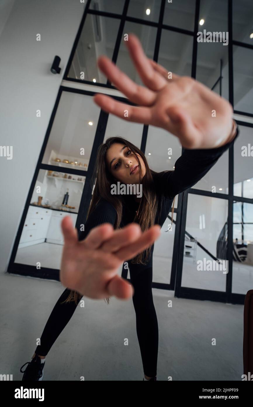Woman in tracksuit leans forward and swings her arms up and down Stock ...