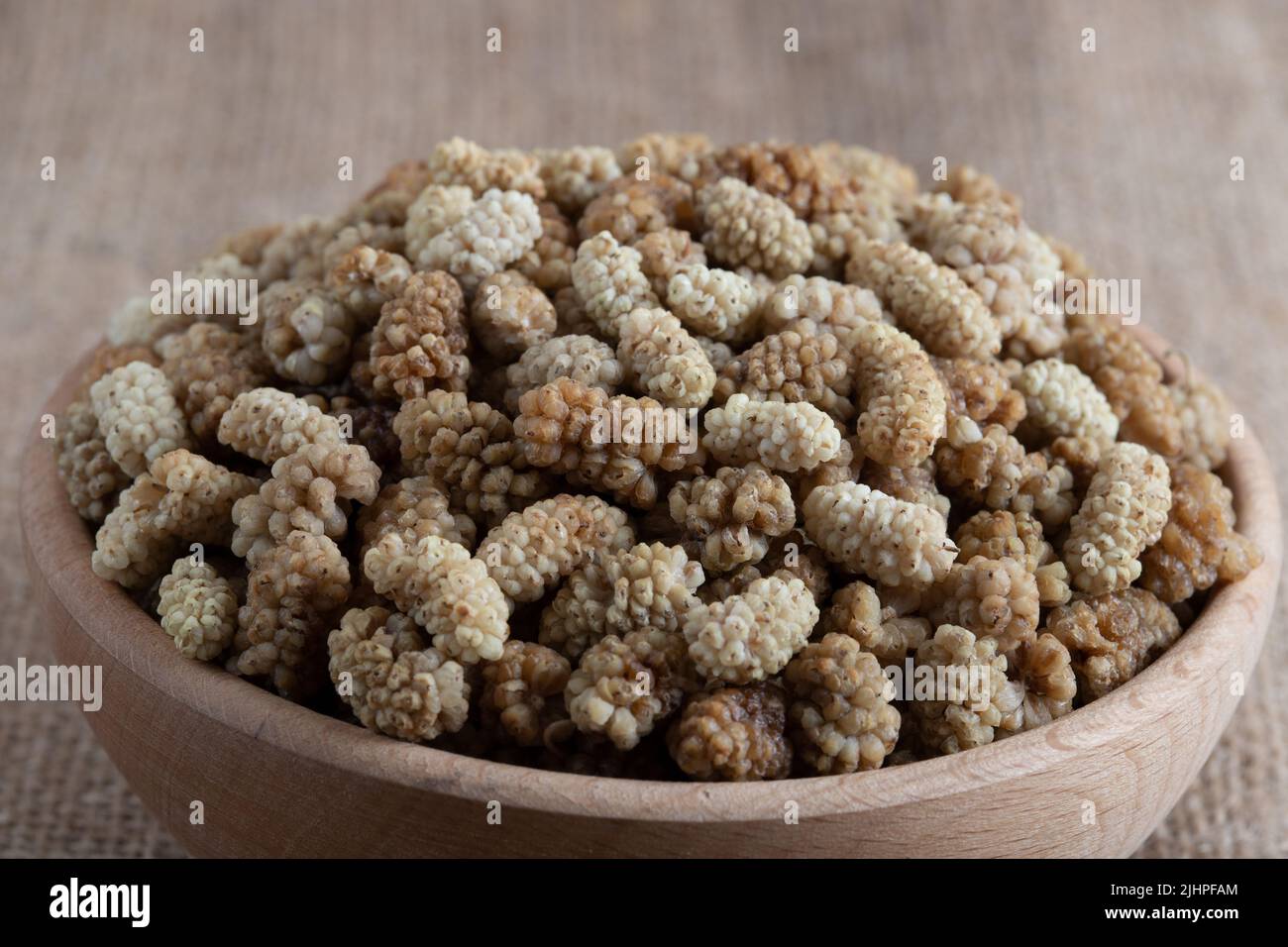 Bowl full of dried mulberry on a fabric background Stock Photo - Alamy