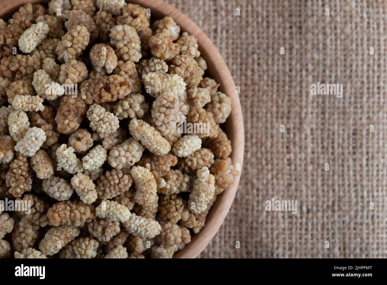 Bowl full of dried mulberry on a fabric background Stock Photo - Alamy