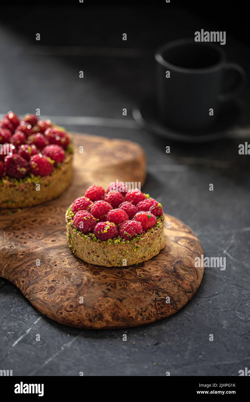 Two delicious raspberry tartlets with pistachios Stock Photo - Alamy