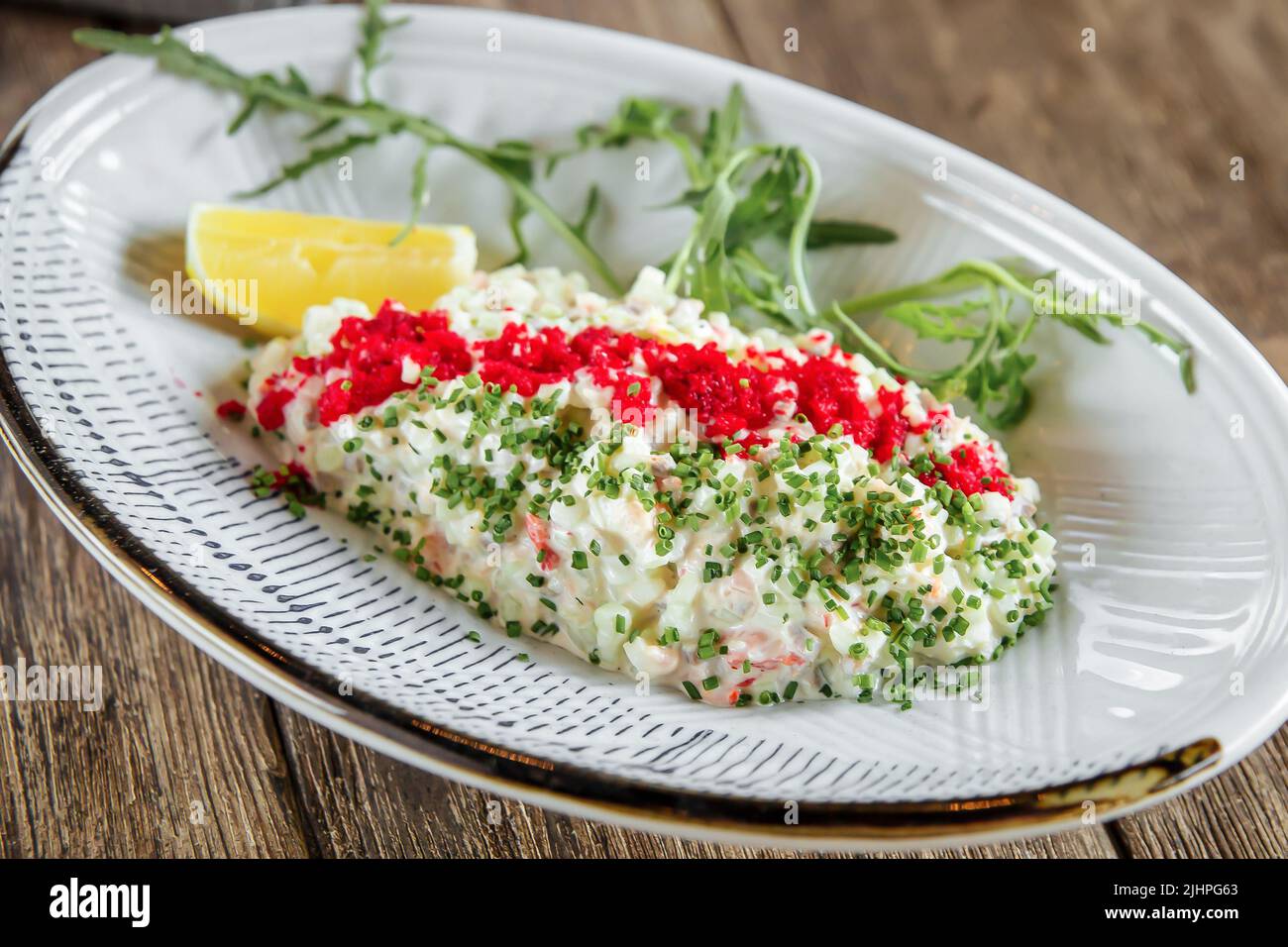 Salad with caviar and crab sticks with wine Stock Photo - Alamy