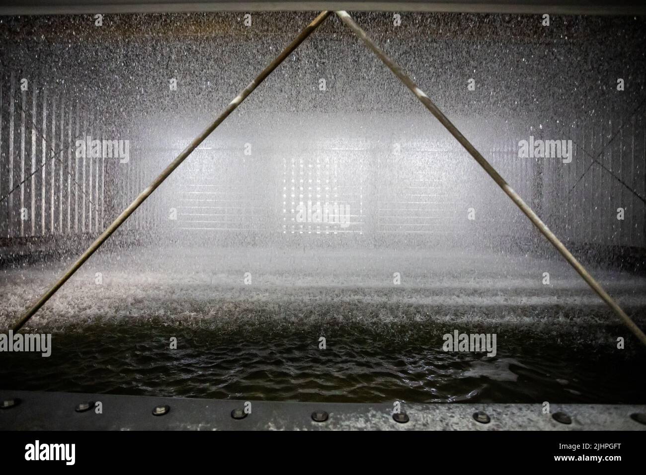 Berlin, Germany. 20th July, 2022. Water falls through a cooling tower ...