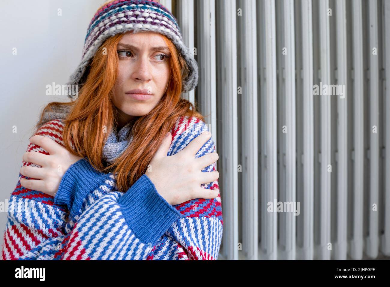 One person feeling cold at home having heating problem Stock Photo - Alamy