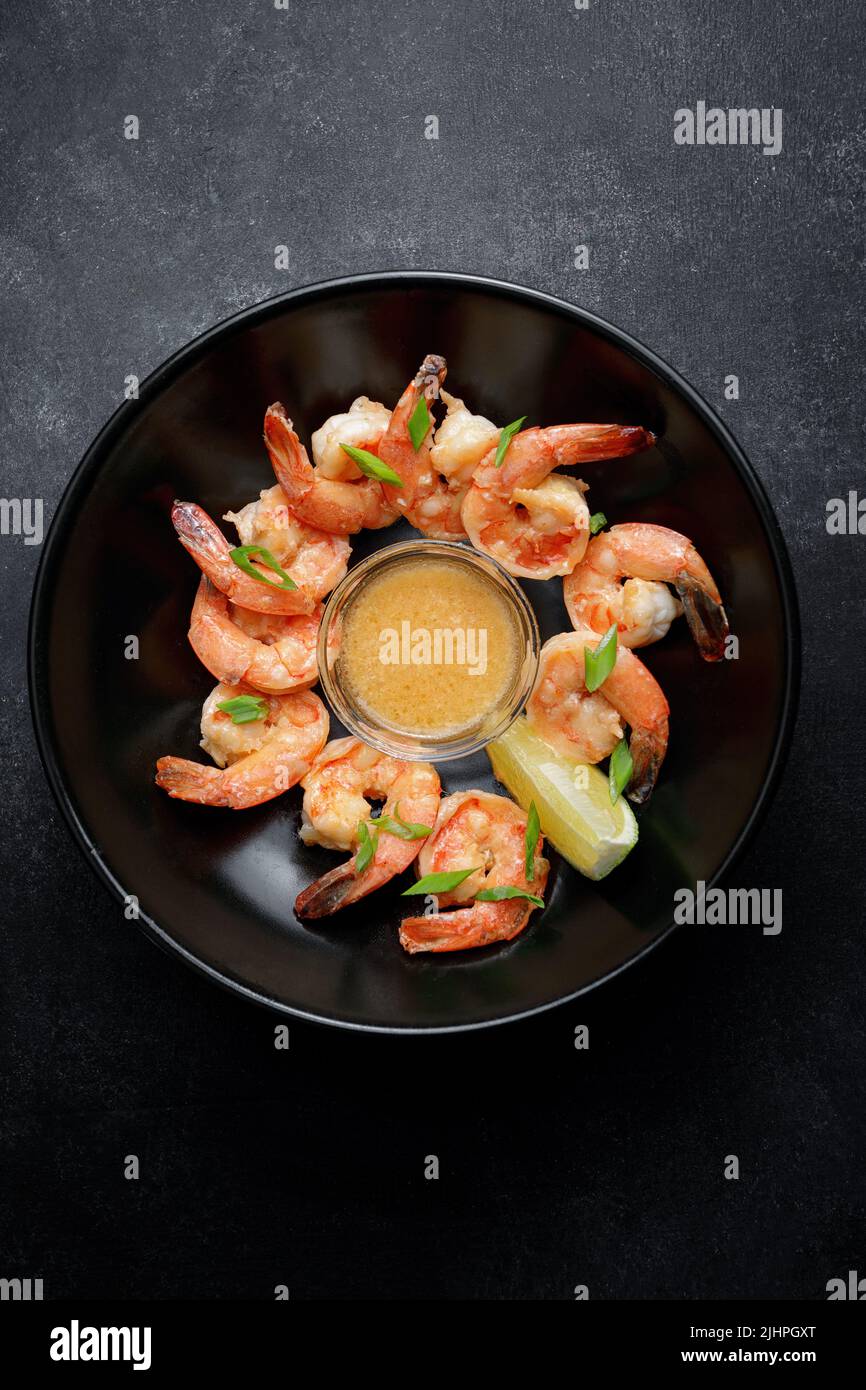 Fried crispy shrimp appetizer, selective focus. On a black background ...