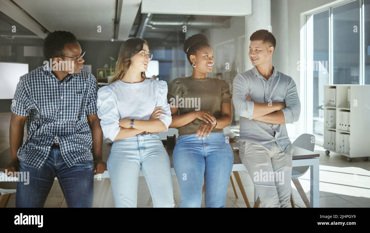 Group of happy businesspeople standing and talking together in an ...