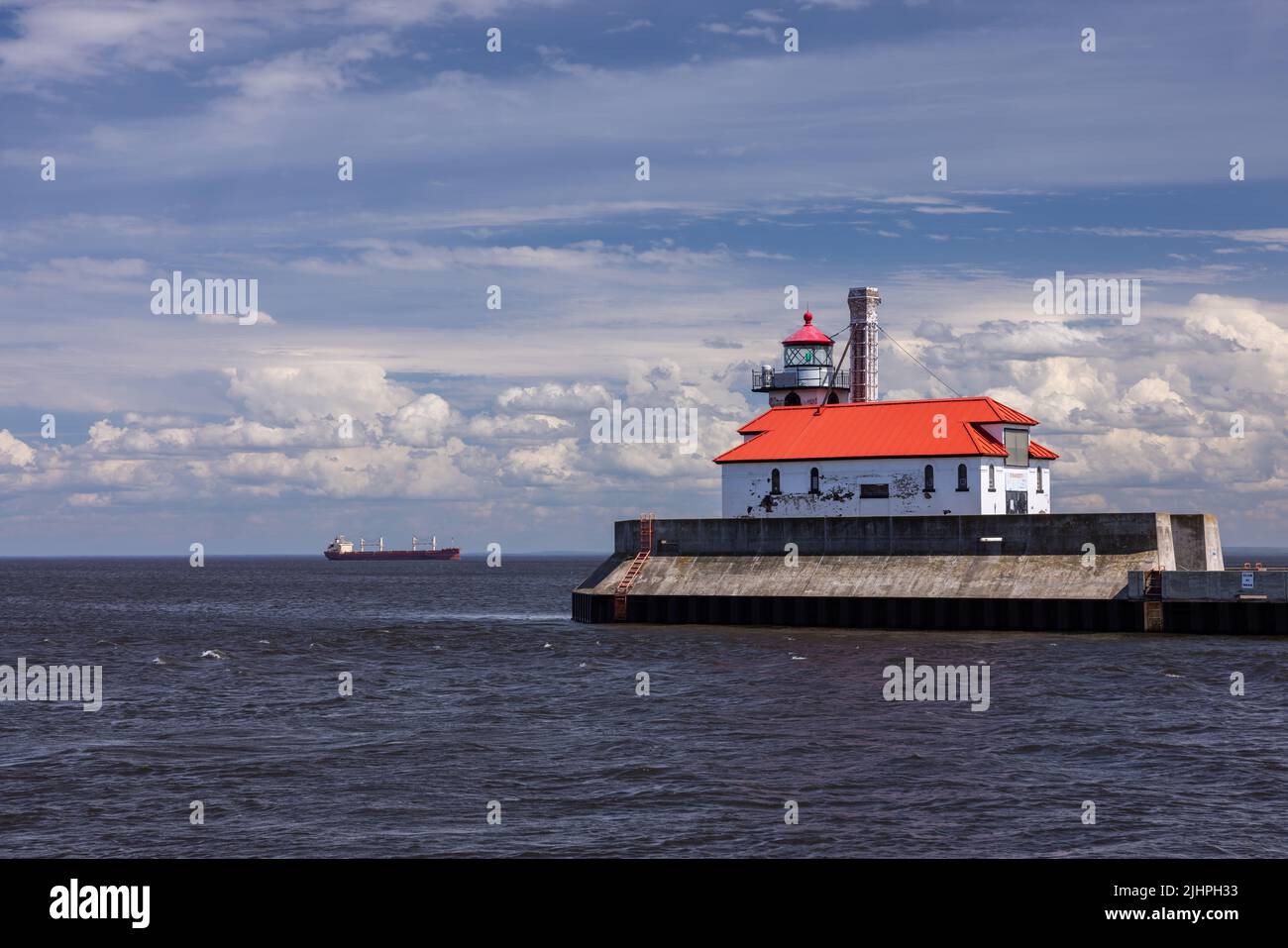 A breakwater with a ship in the background on Lake Superior Stock Photo ...