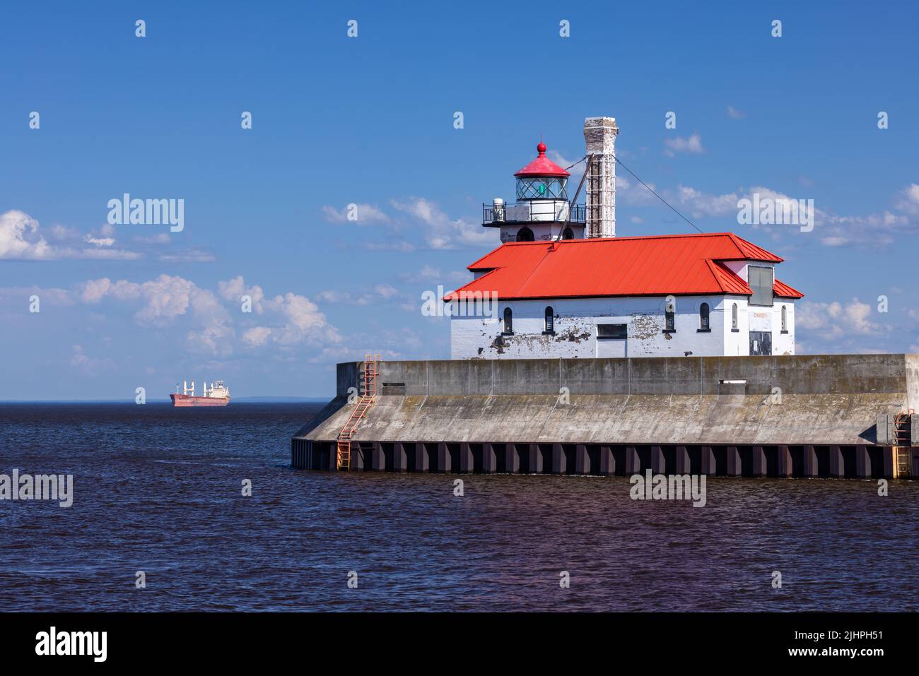 A breakwater with a ship in the background on Lake Superior Stock Photo ...