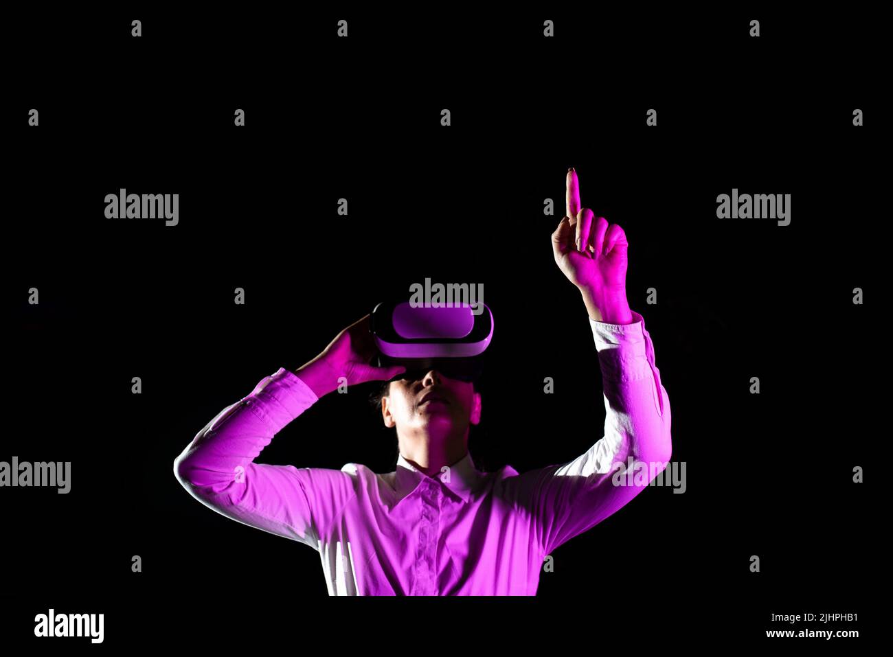 Female Manager Wearing Virtual Reality Goggles Raising Hand While ...