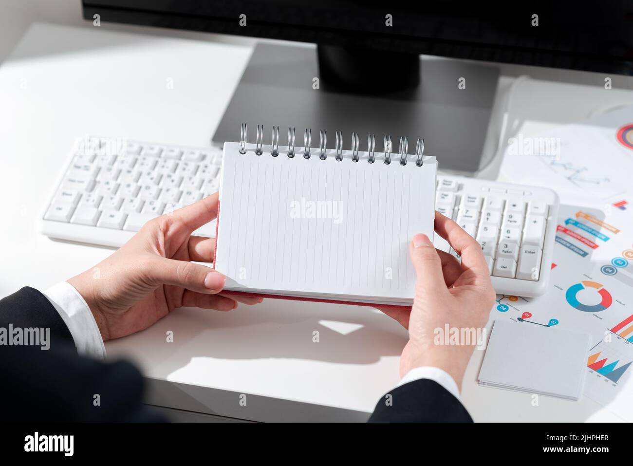 Businesswoman Holding Notebook With New Ideas Over Desk With Computer ...