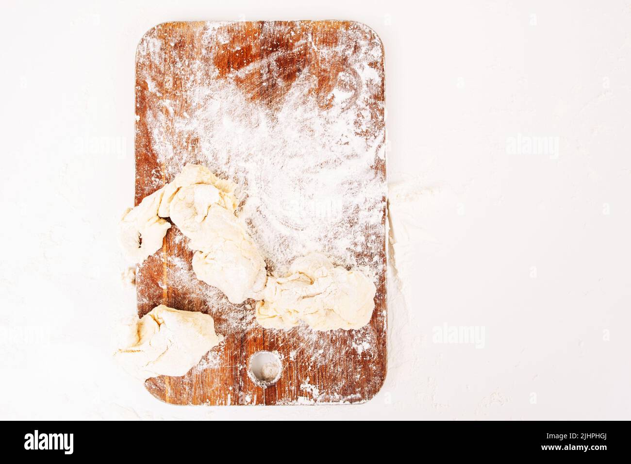 Floured cutting board with raw dough top view Stock Photo - Alamy