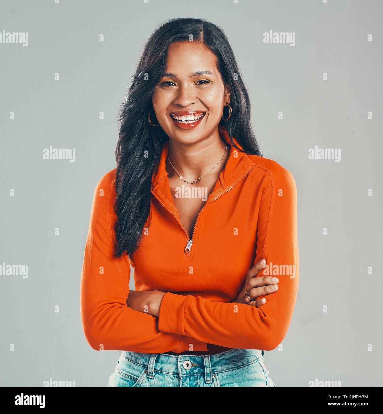Portrait of smiling mixed race woman isolated on grey studio background ...