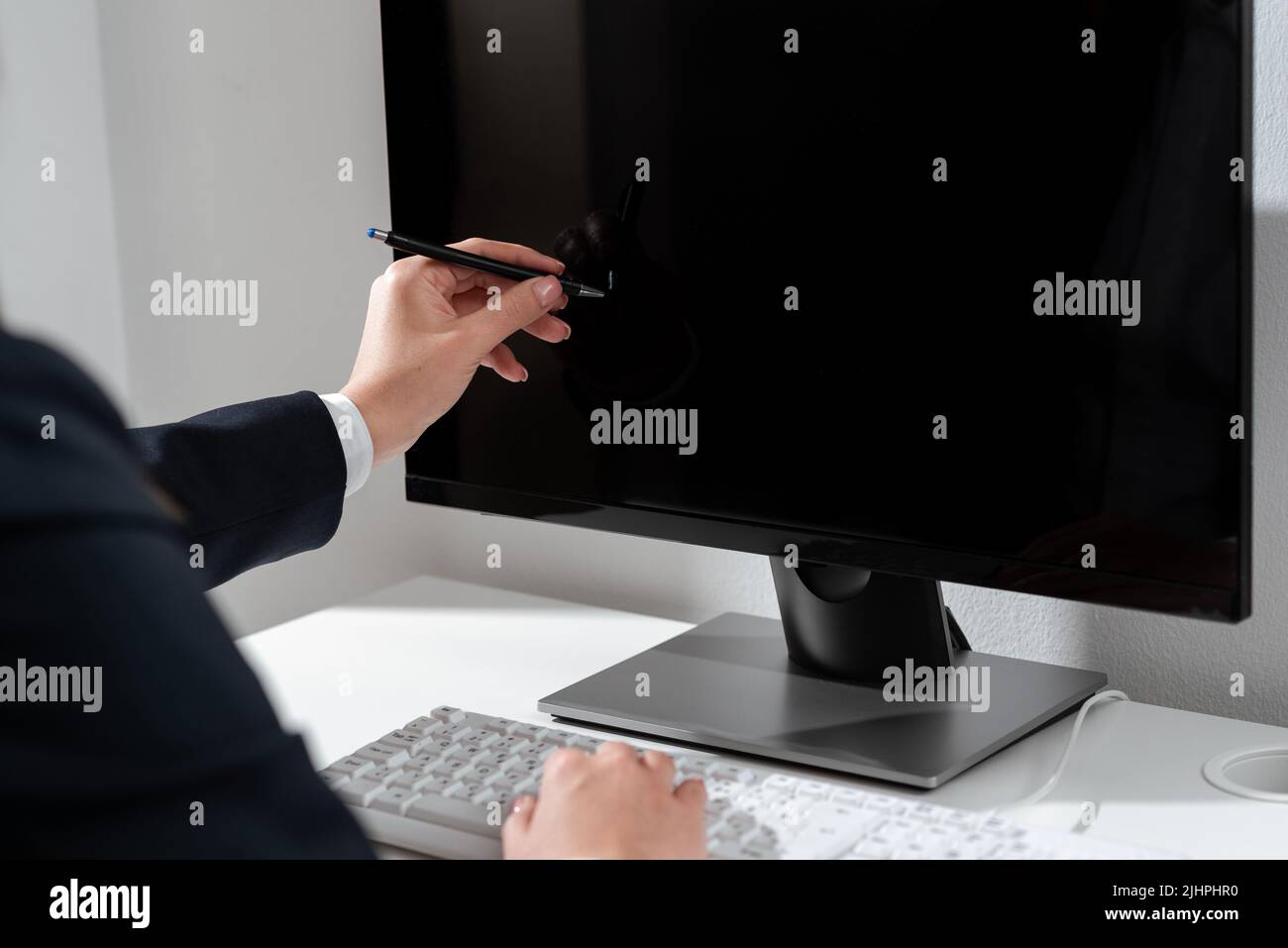 Businesswoman Pointing Important Infortmation With Pen On Computer ...