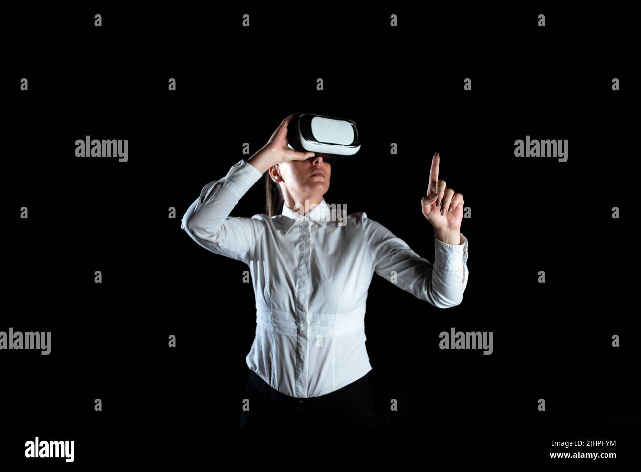 Female Professional Wearing Virtual Reality Headset Gesturing And ...
