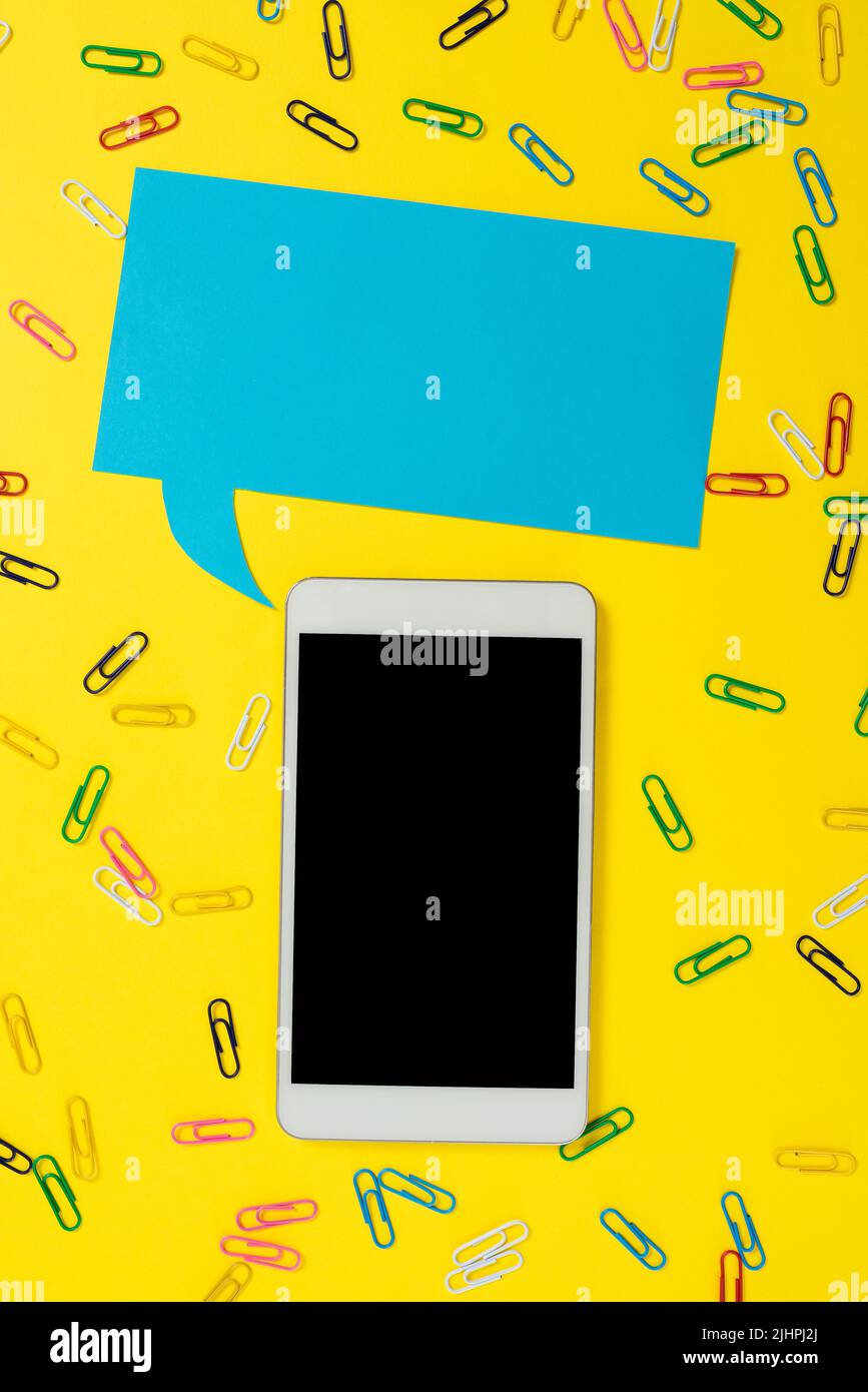 Colorful Paperclips Placed Around Tablet And Speech Bubble With ...