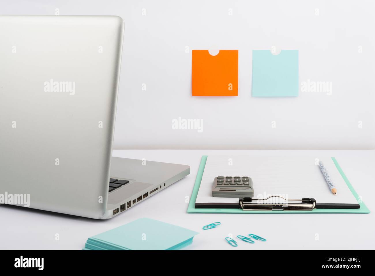 Important Messages On Two Notes On Desk With Lap Top, Paperclips And ...