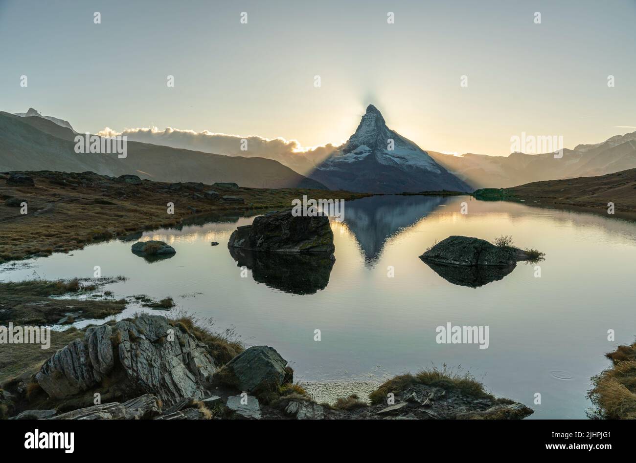 Panoramic evening view of Lake Stellisee with the Matterhorn Cervino Peak in the background ...