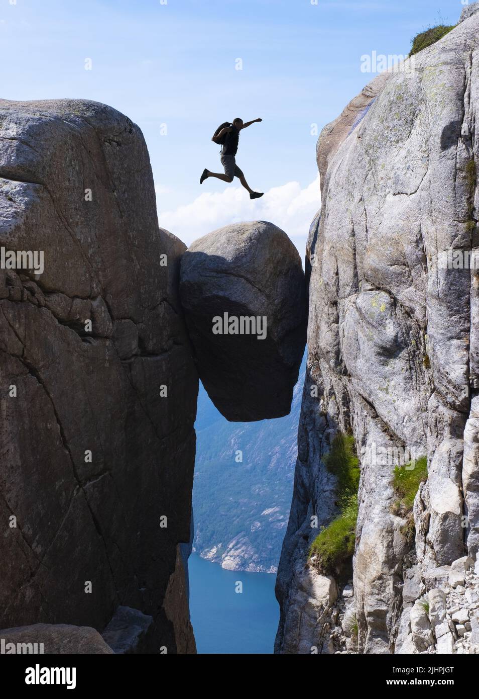 Man jumping between mountains, business concept idea Stock Photo - Alamy