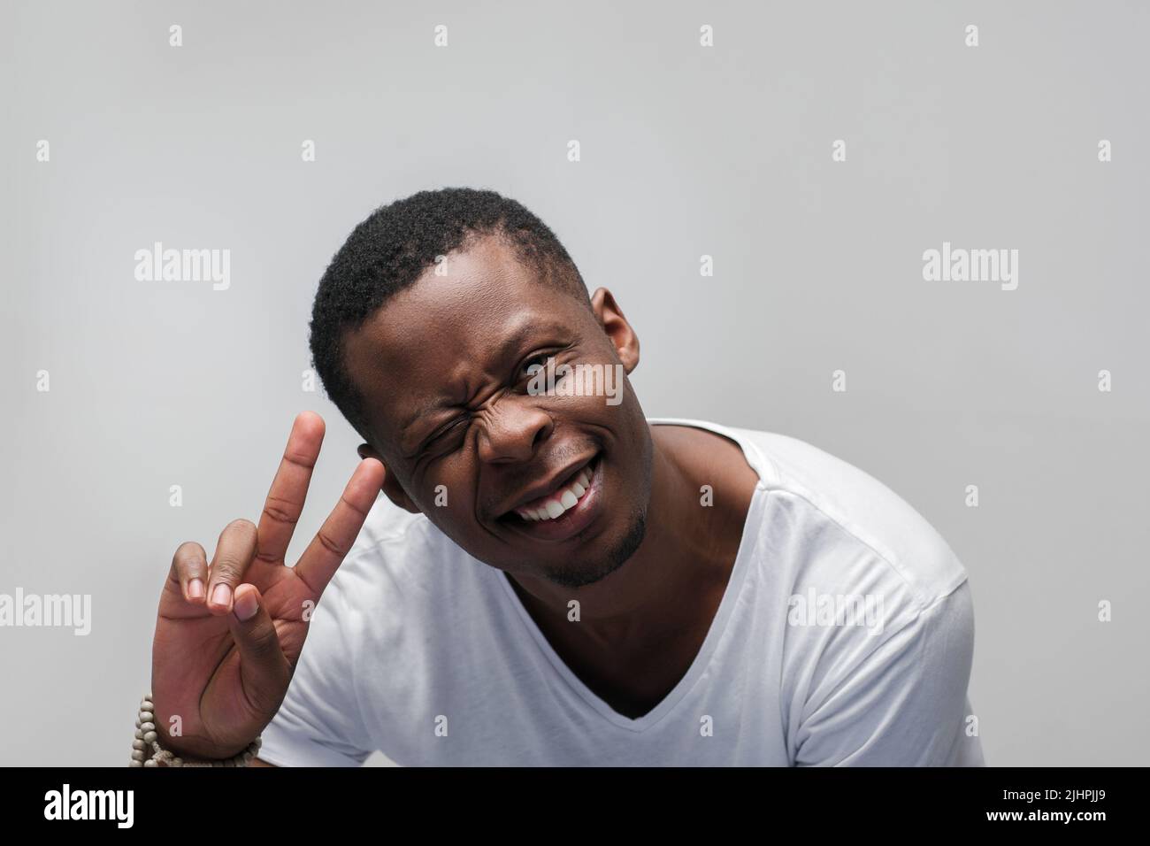 Happy winking black guy full of joy and happiness Stock Photo - Alamy