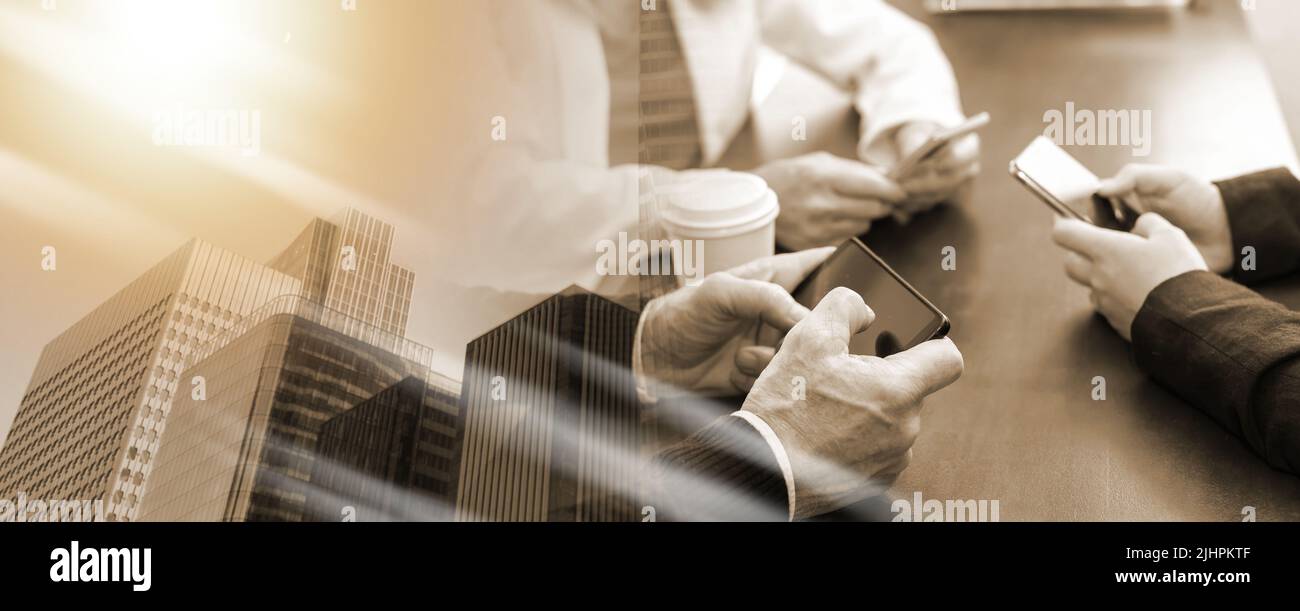 Group of people using and looking at mobile phone together; multiple ...