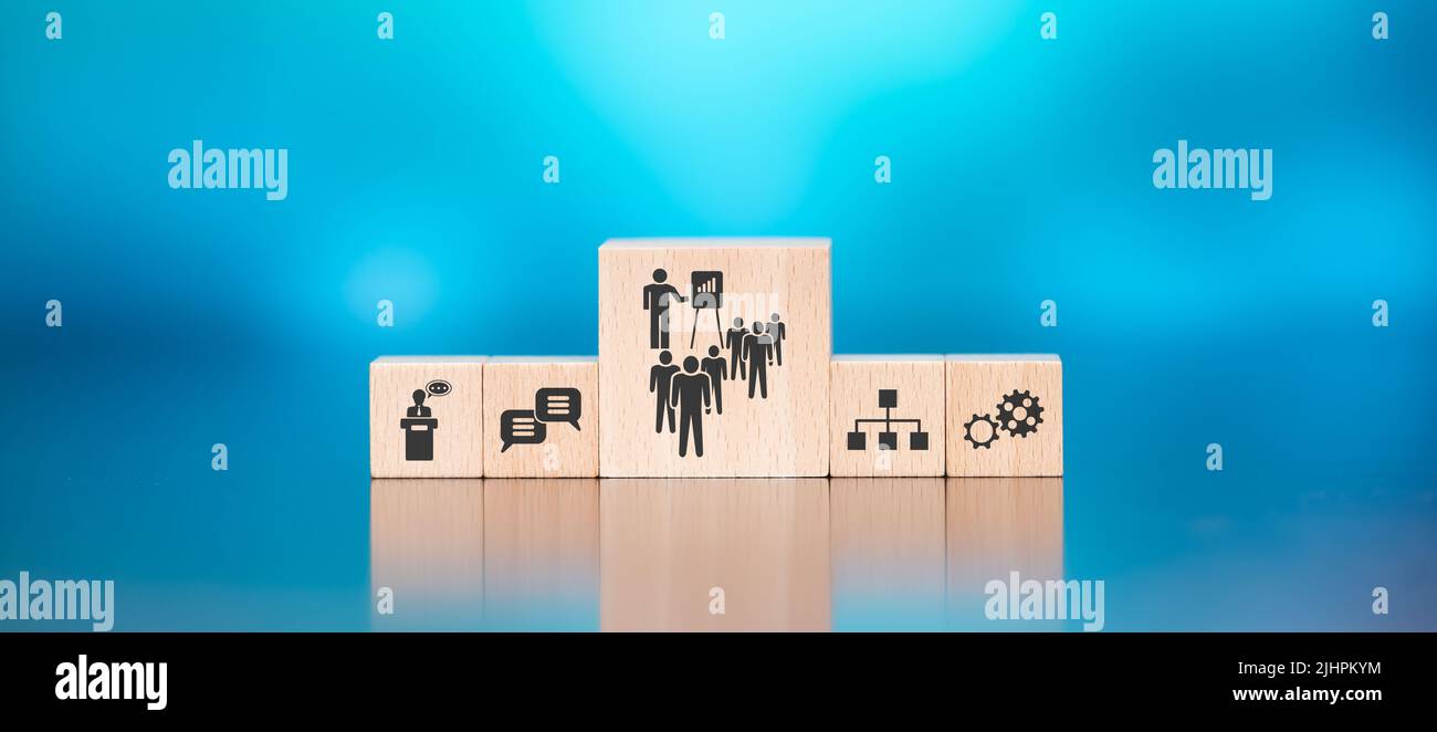 Wooden blocks with symbol of seminar meeting concept on blue background ...
