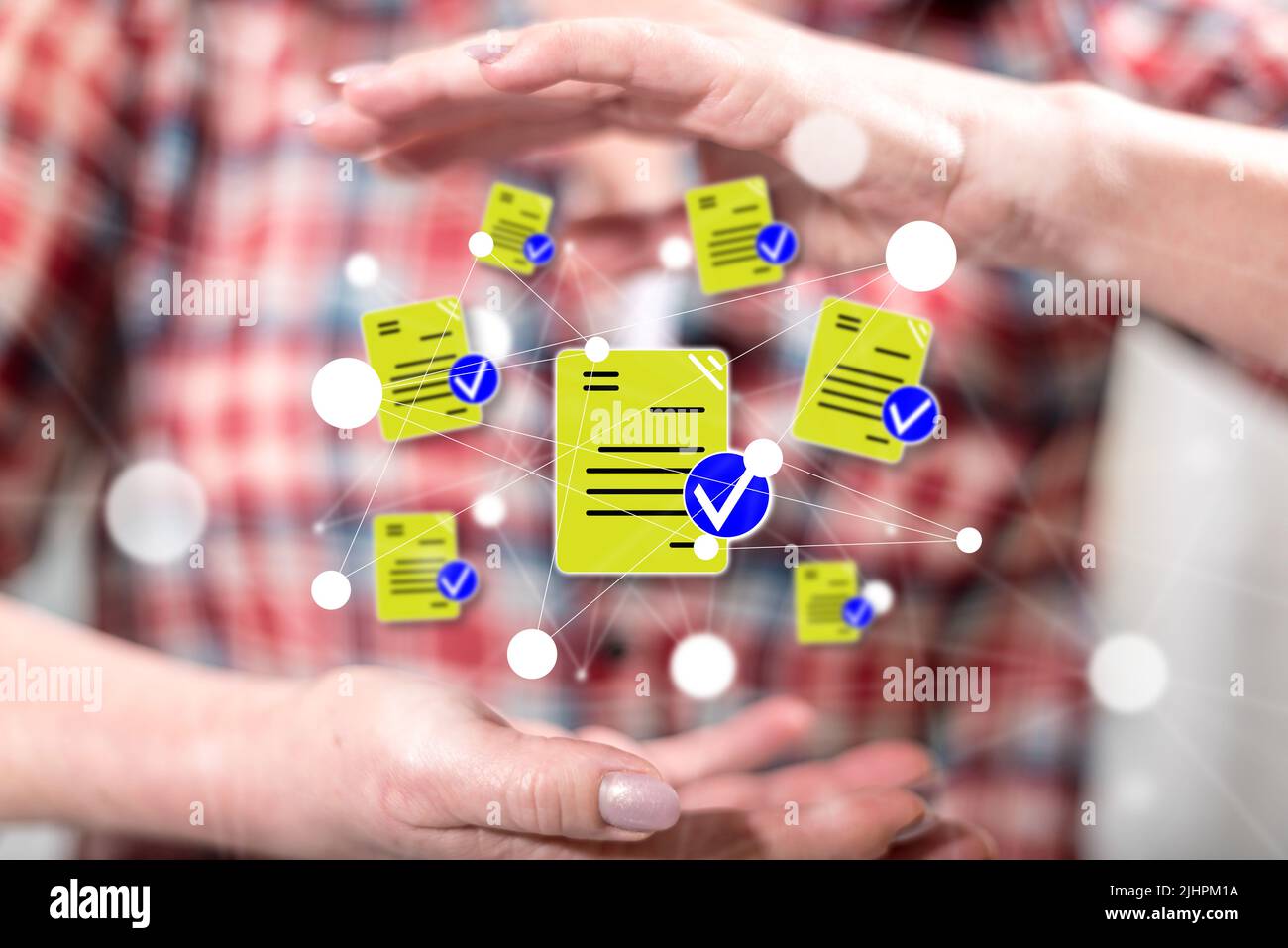 Document validation concept between hands of a woman in background ...