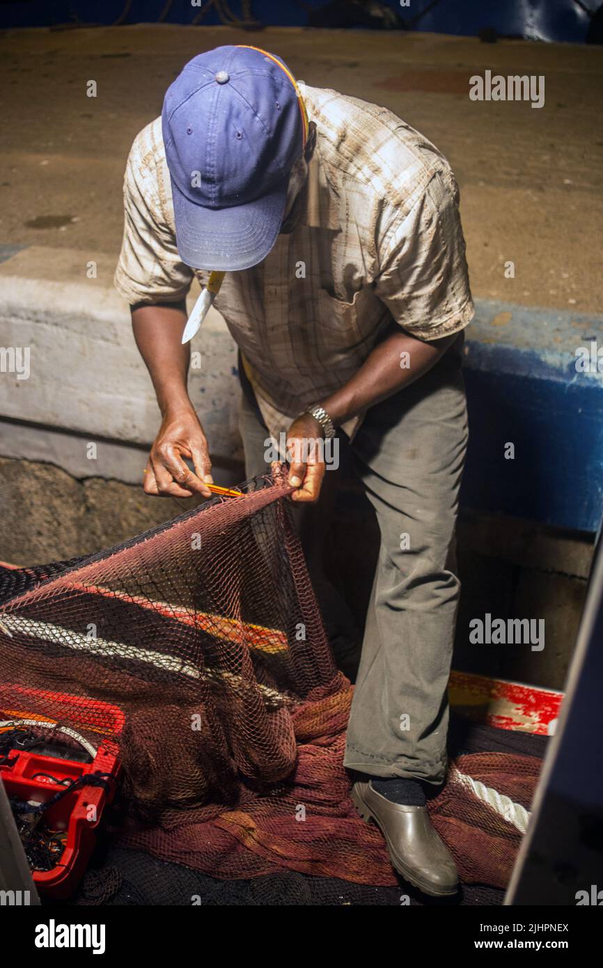 Fisherman fixing net Stock Photo - Alamy