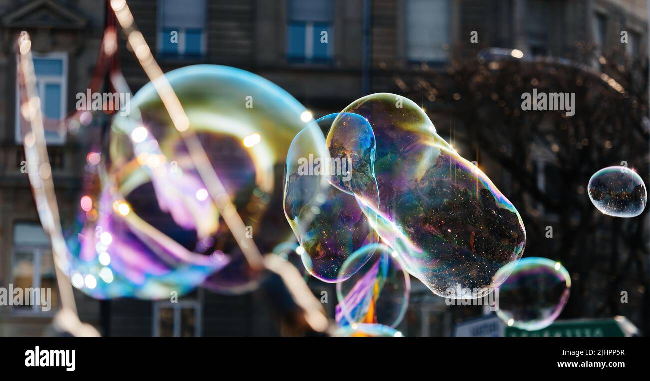 Multiple balloon bubble made from soap - flying above the city with ...