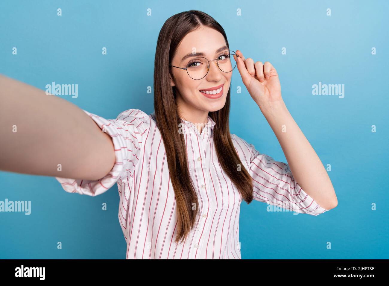 Self portrait of attractive cheerful skilled girl touching specs ...